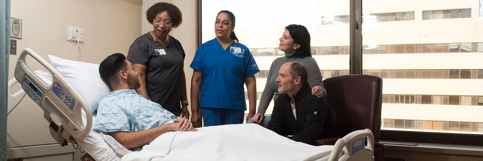 Patient In Hospital Bed With Family